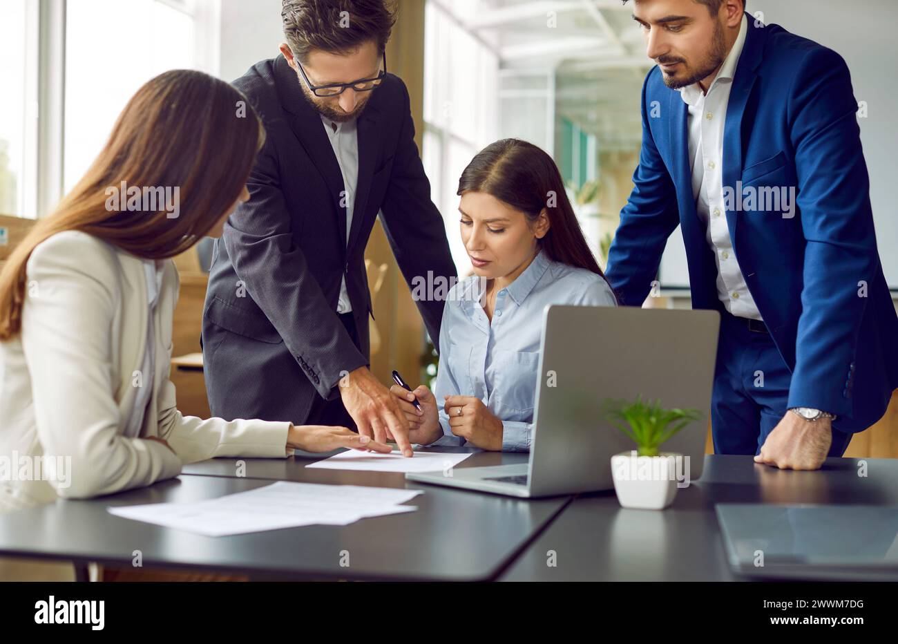 Group of business people having a meeting in office, signing a contract ...