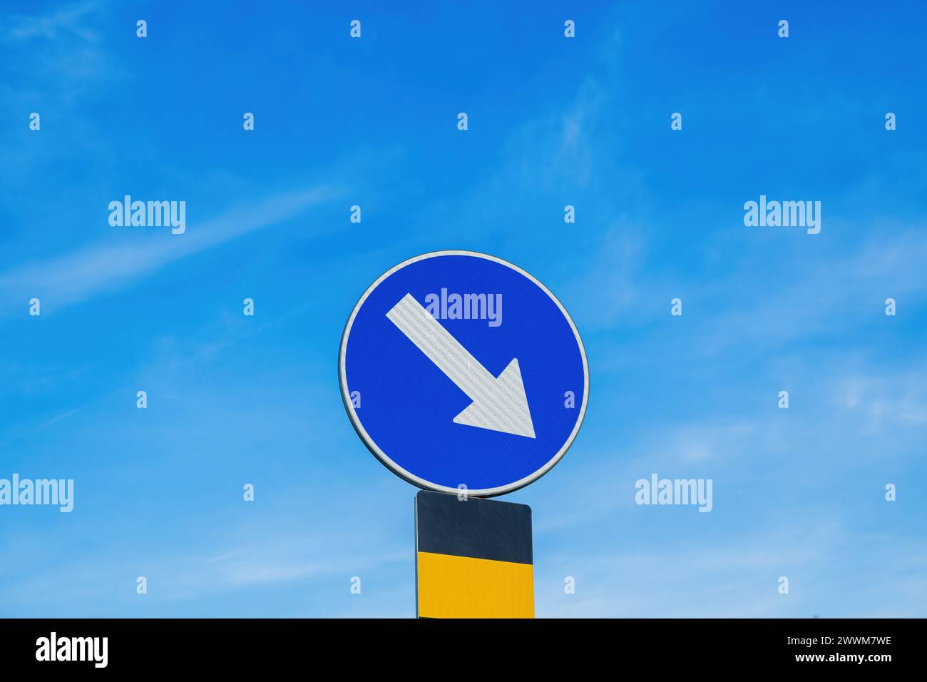 Mandatory carriageway keep right traffic sign in front of the ...