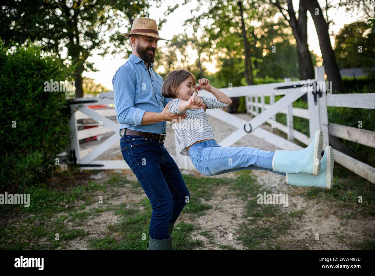 Father and young daughter having fun on family farm, farmer family ...