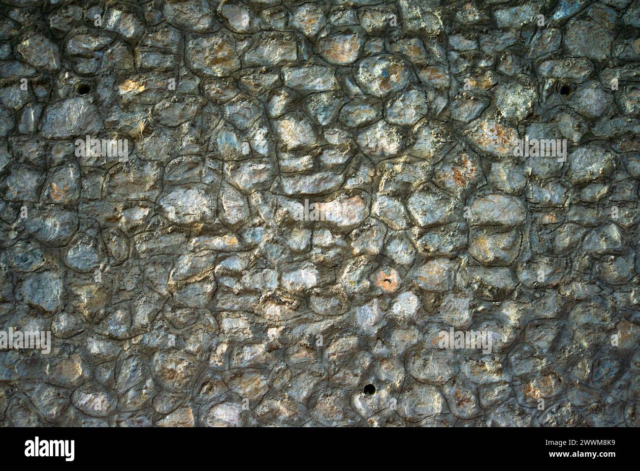 An ancient stone wall stands as a timeless monument, weathered and moss ...