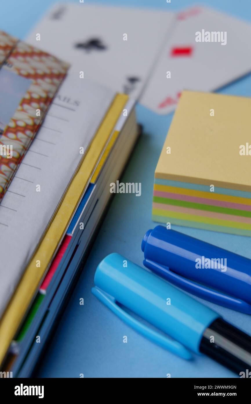 The photo is a photo of stationery in the form of books, pens, and ...