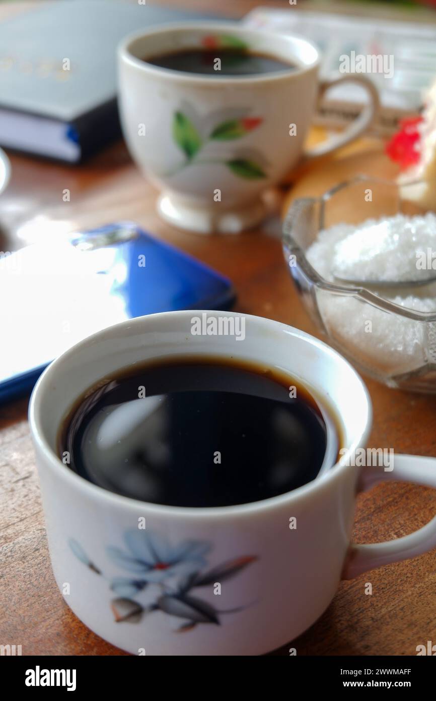 Close-up photo of someone drinking tea in the front yard of his house ...