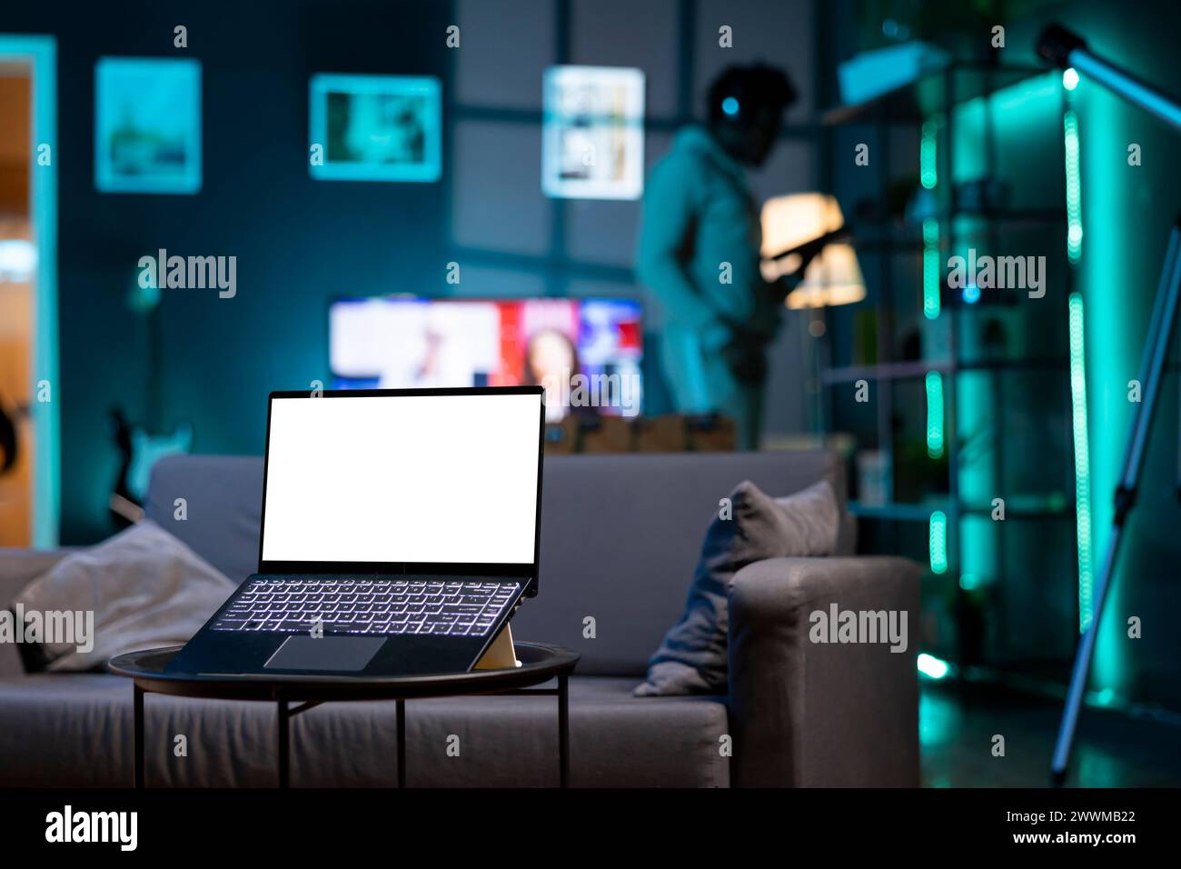 Focus on isolated screen laptop on coffee table in apartment with man ...