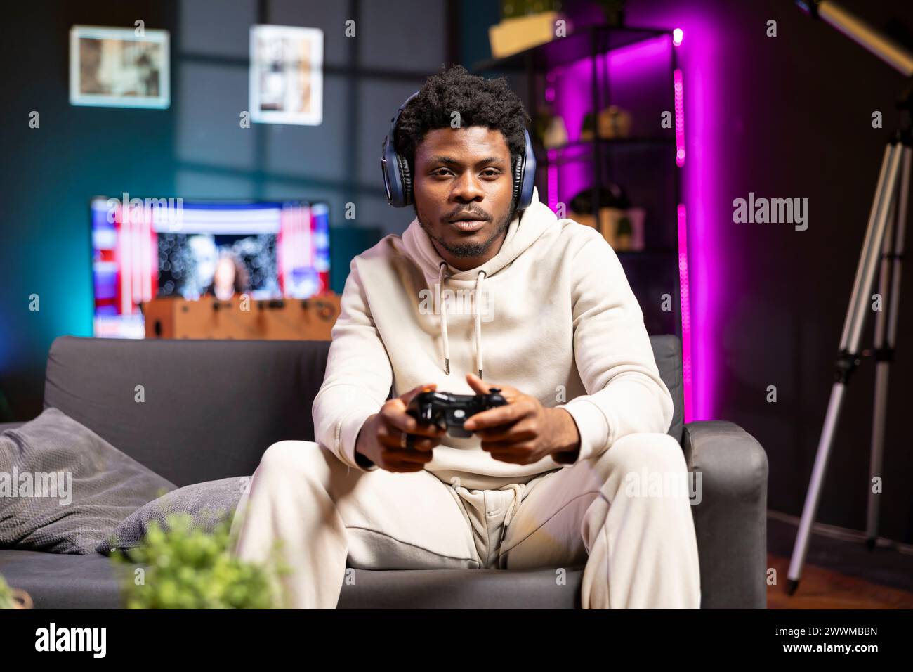 Man sitting on couch at home, relaxing by playing videogames on gaming ...