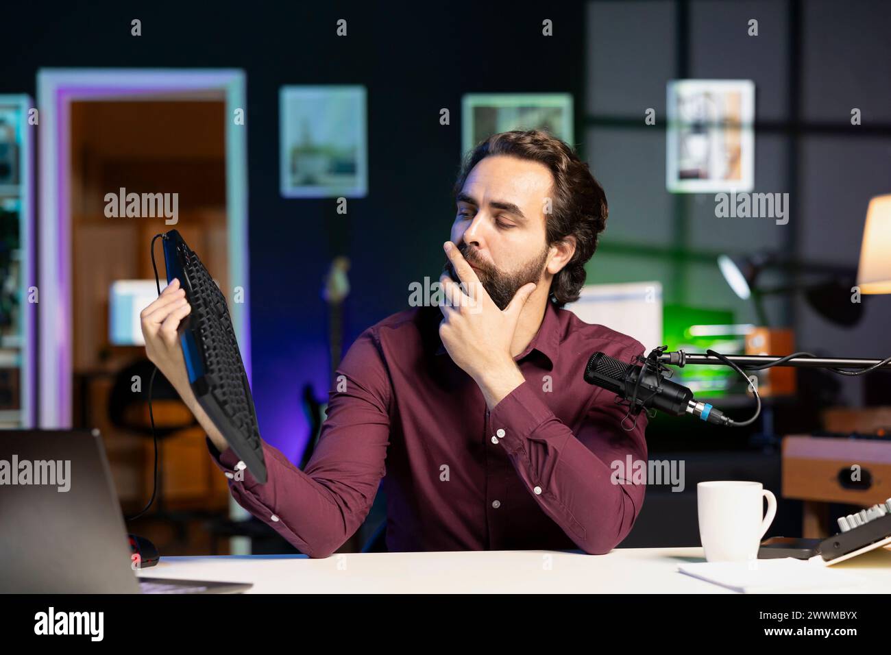 Influencer filming keyboard review in personal studio, thinking how to ...