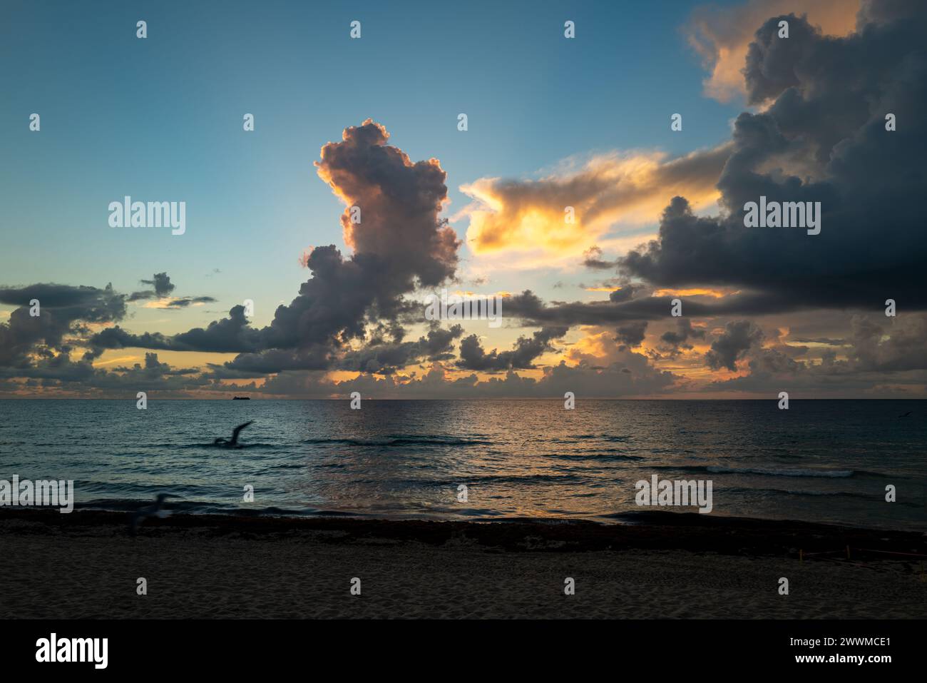 Sunset sea. Calm sea with sunset sky through the clouds over ...