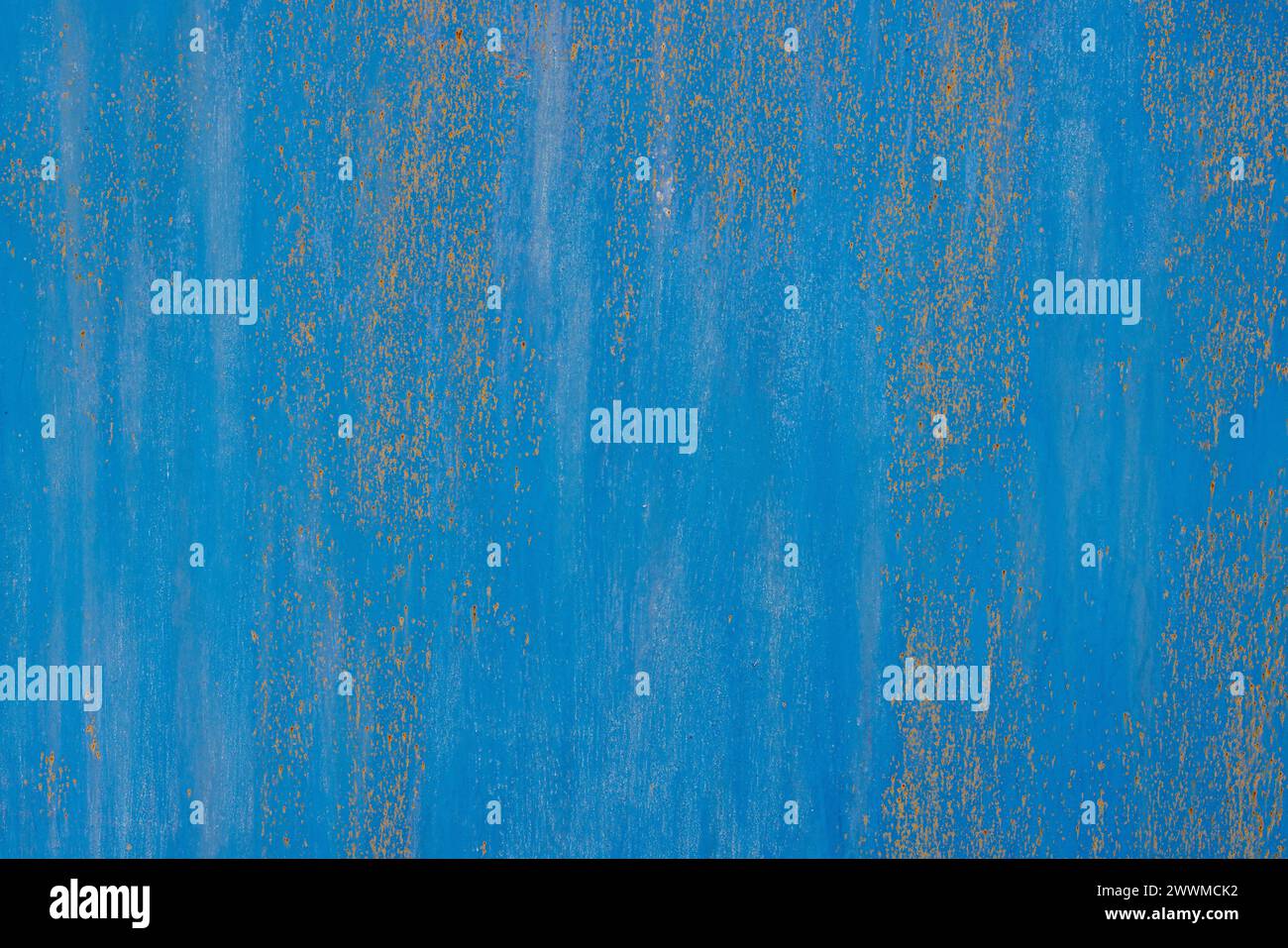small spots of rust on rough blue flat vertical sheet metal surface ...