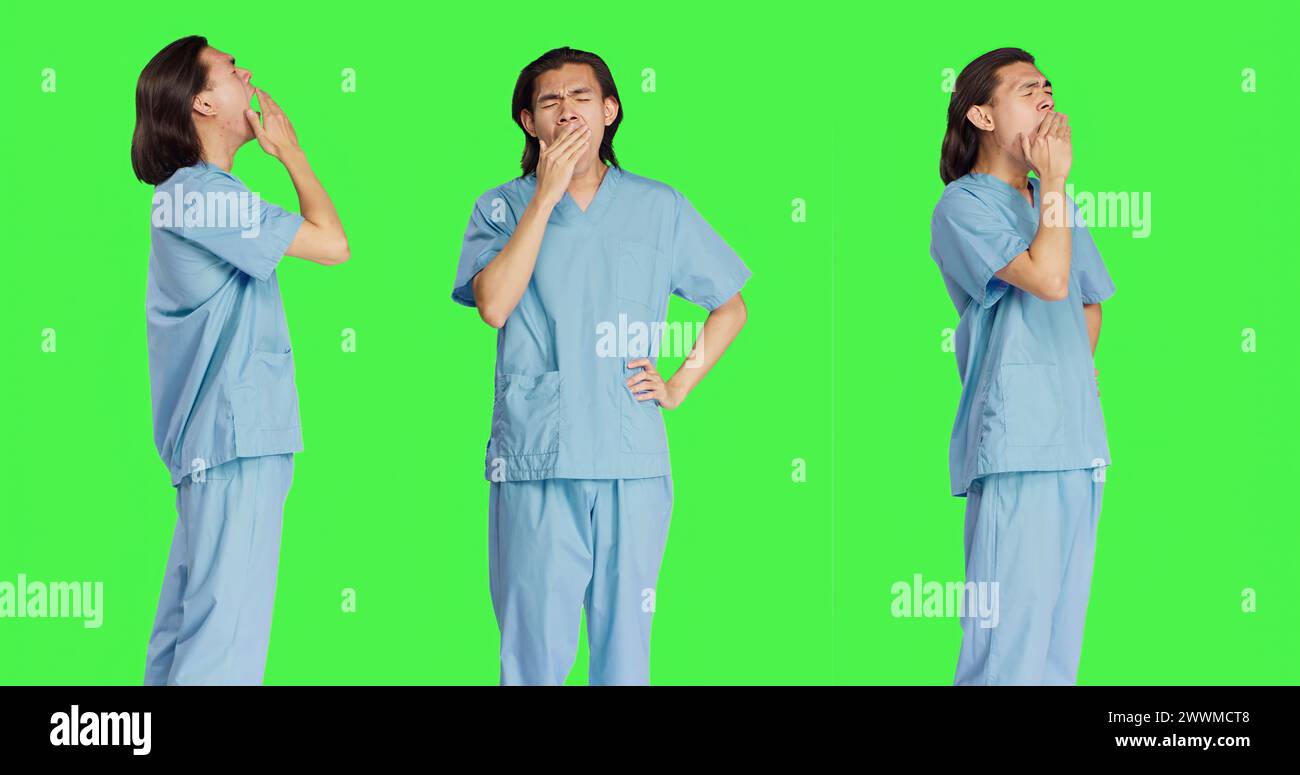 Tired healthcare worker yawning in studio over greenscreen, feeling ...