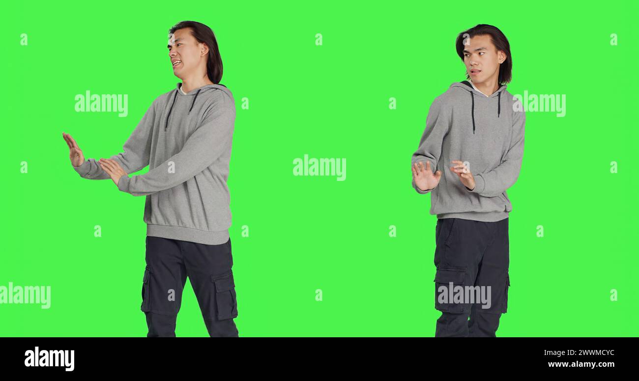 Male model pretending to push something aside, expressing rejection or ...