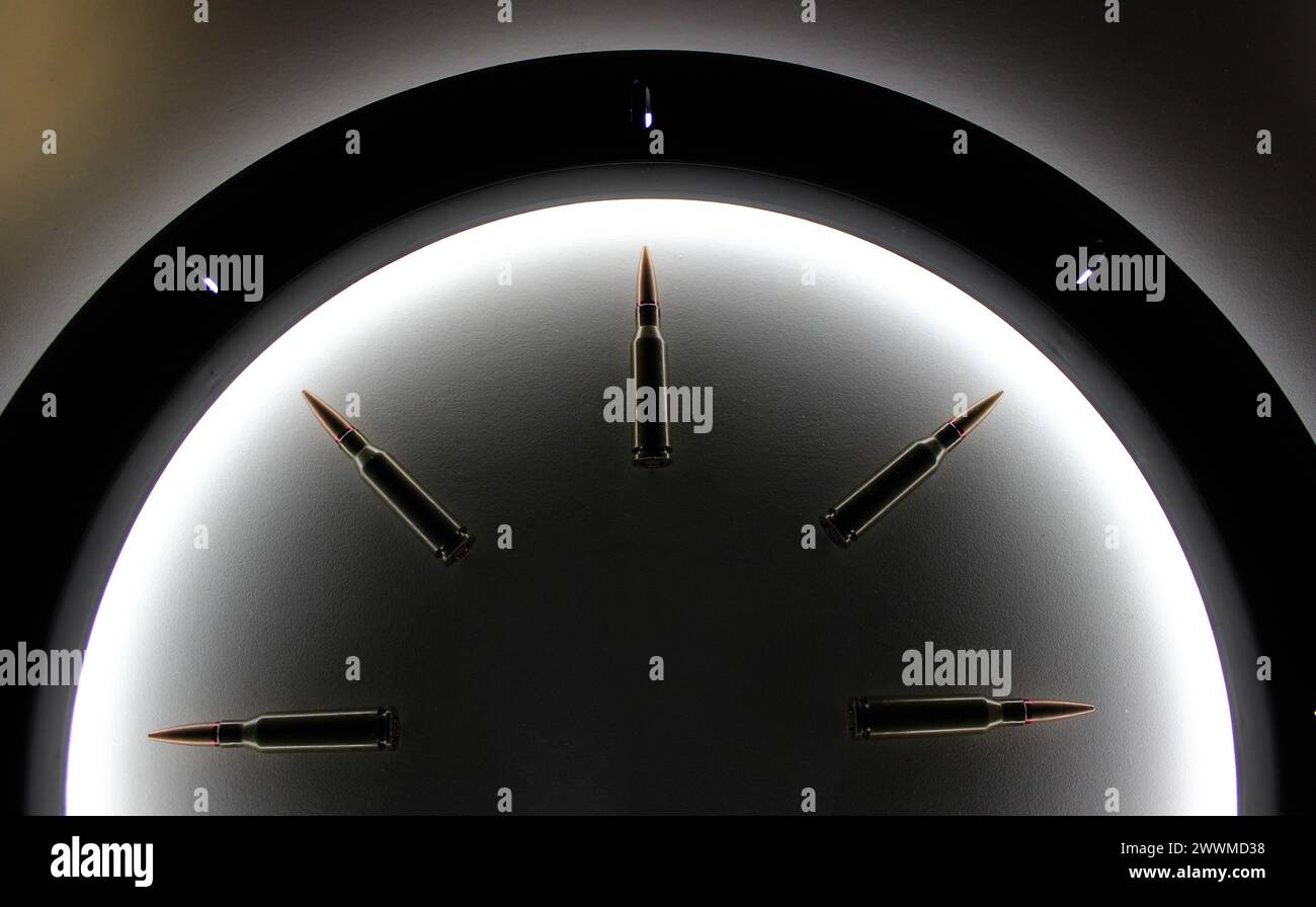 Top part of classic clock dial made of bullets inside a circle of light ...
