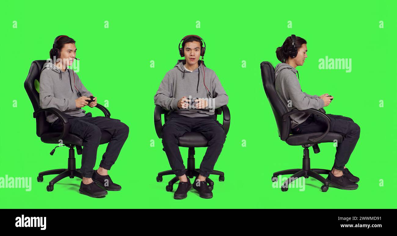 Asian man using controller for contest, sitting on chair against full ...
