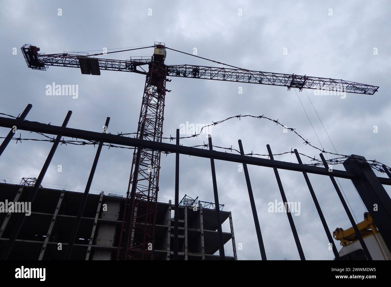 Tower construction crane over an unfinished high-rise building on a ...