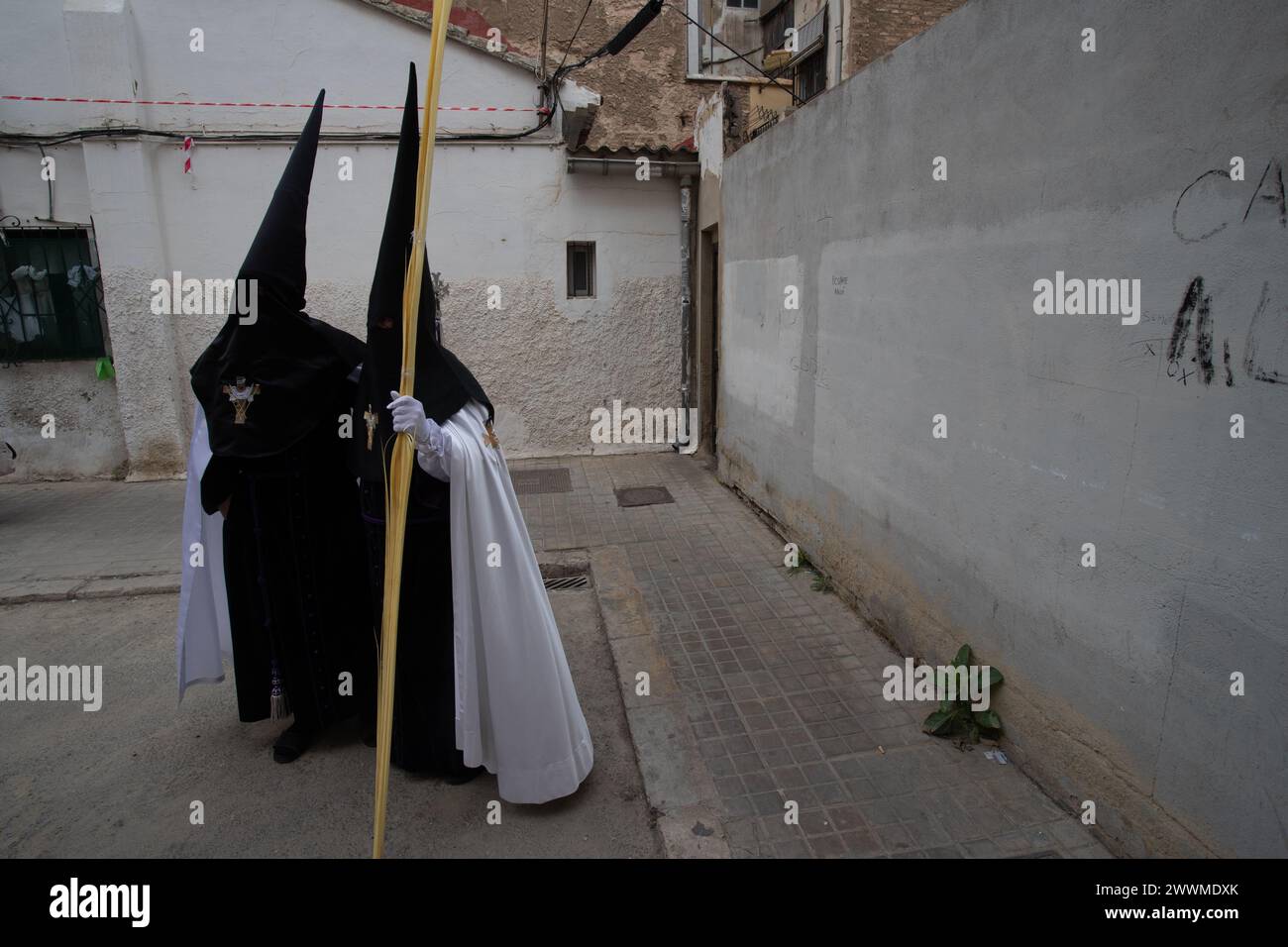 Penitents during a Holy week parade at Cabanyal quarter in Valencia ...