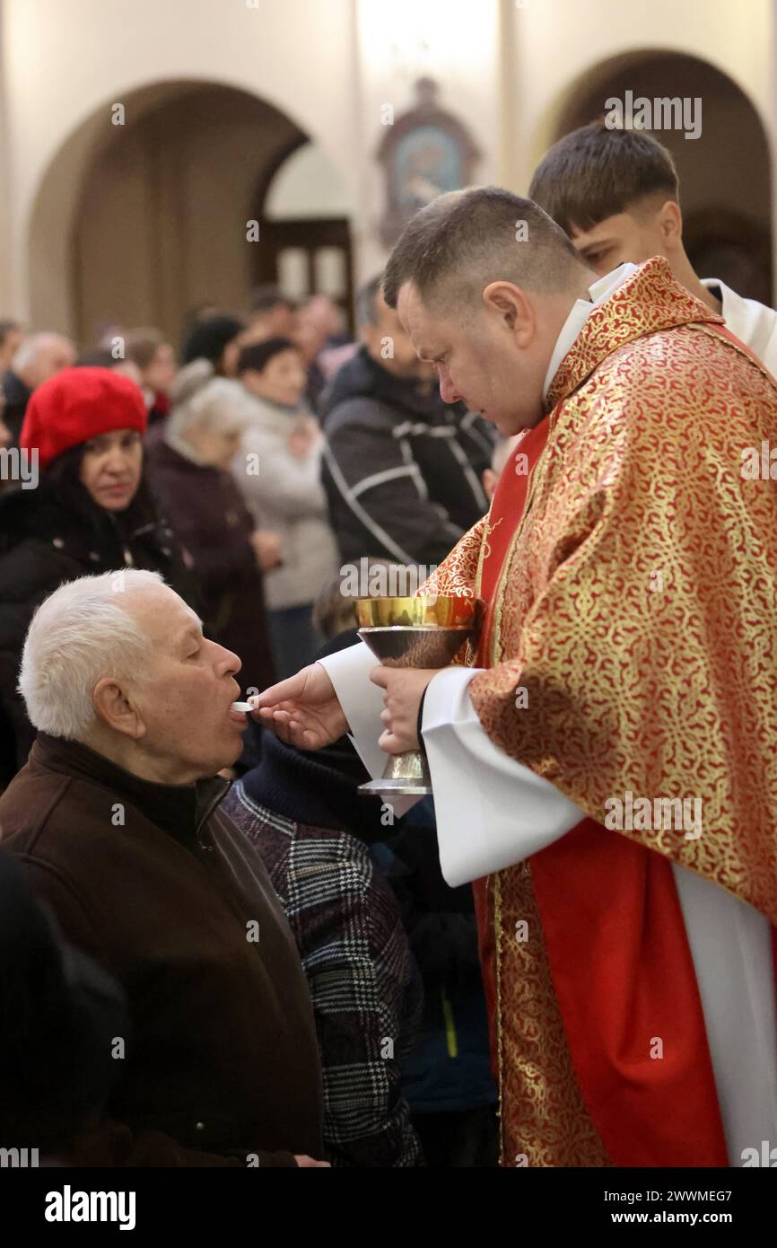 IVANO-FRANKIVSK, UKRAINE - MARCH 24, 2024 - A priest offers communion ...