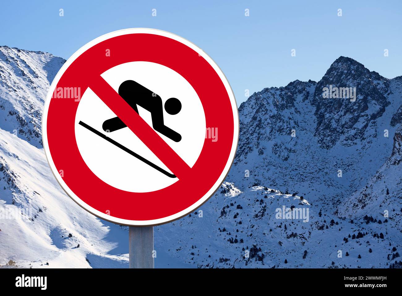 Round forbidden sign with with a man skiing symbol drawn in the middle ...