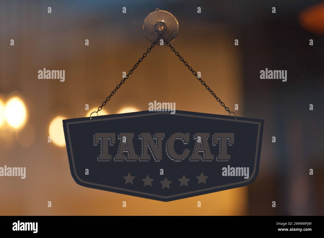 Old fashioned sign in the window of a shop saying in Catalan "Tancat ...