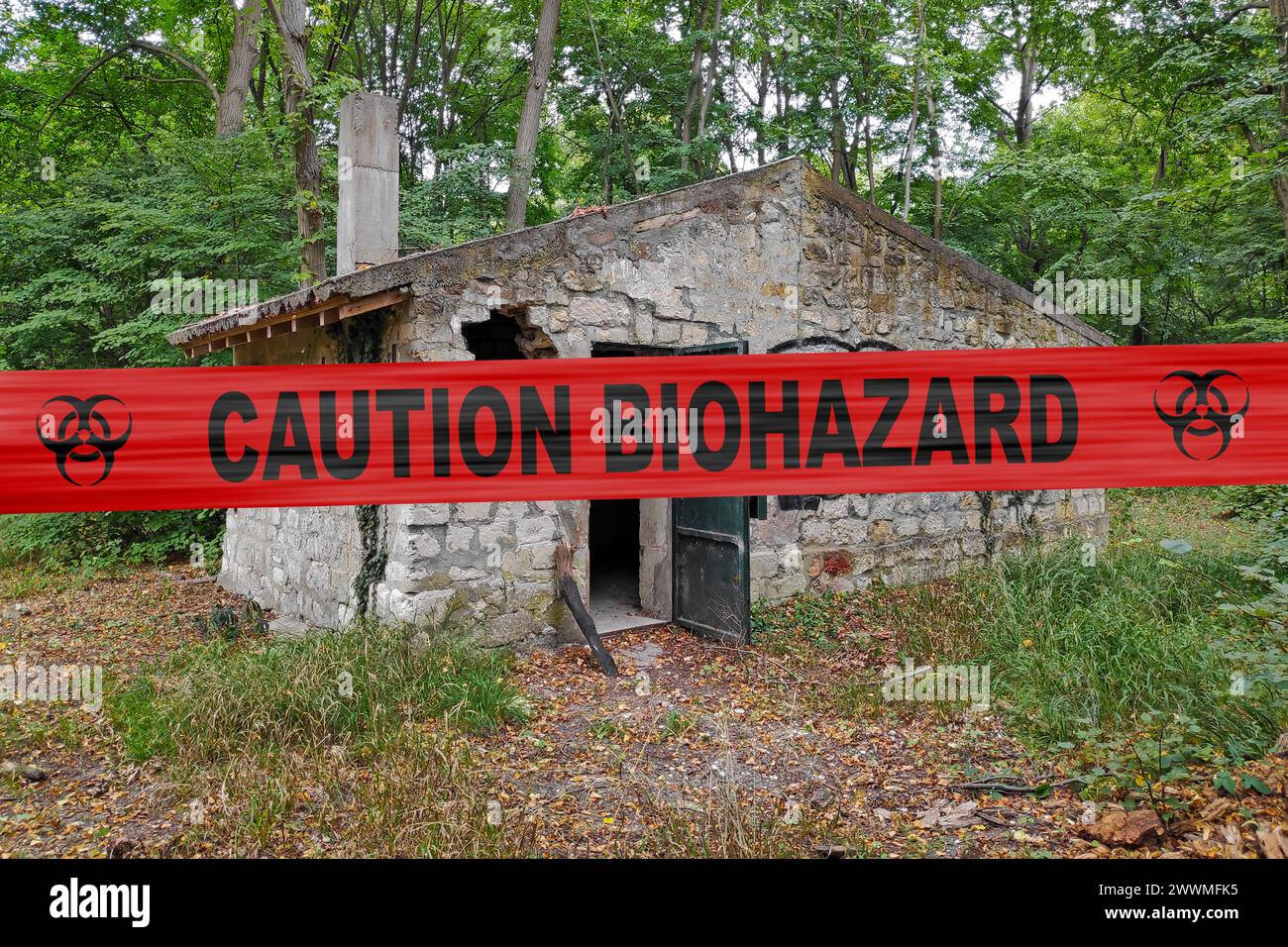 Abandoned stone house in the woods with a police tape with written in ...
