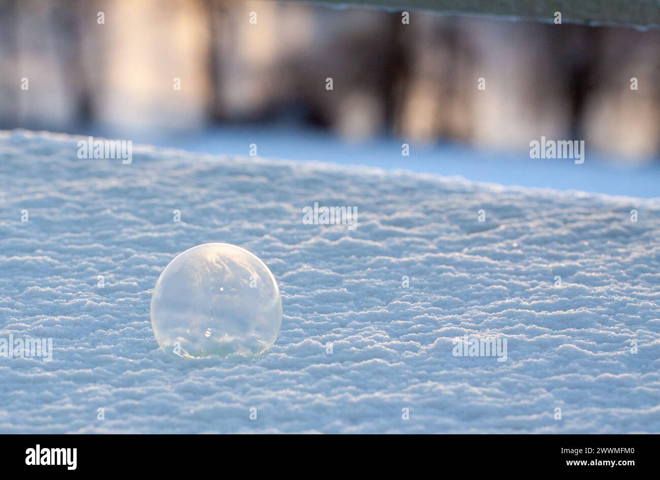 A tiny bubble on top of the snowy ground Stock Photo - Alamy