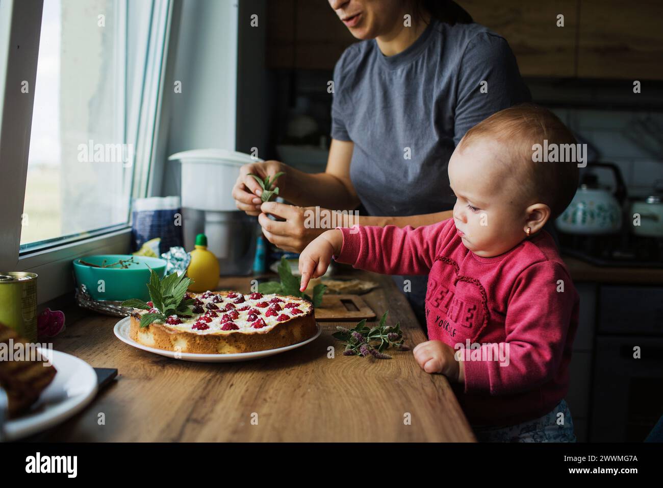 A small child touches a cake with his finger Stock Photo - Alamy