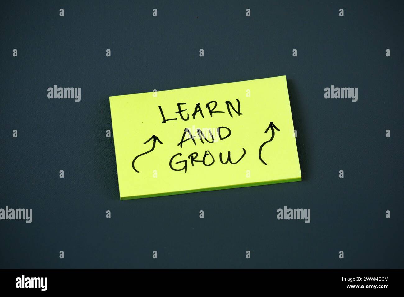 Writing learn and grow on stick notes. Word concept Learn and grow with ...
