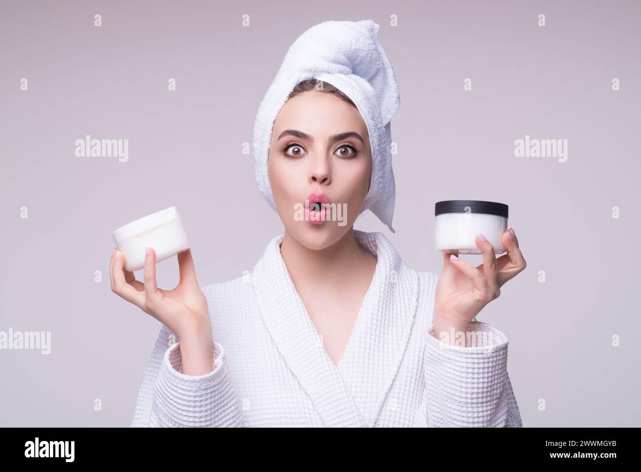 Skin care. Beauty portrait of a beautiful woman applying face cream ...