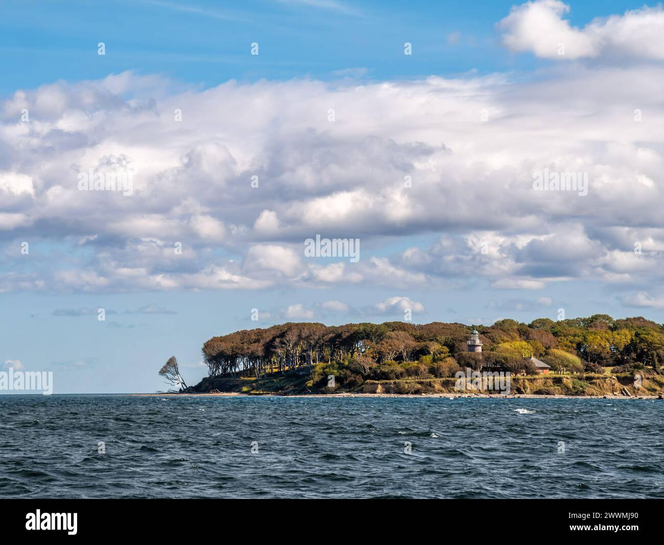Coastline of northern area of Aebelø Island with lighthouse on bluff in ...