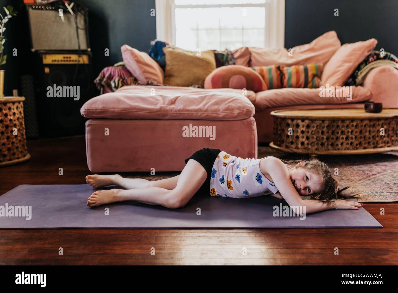 Girl lays on floor while looking at the camera and smiling Stock Photo ...