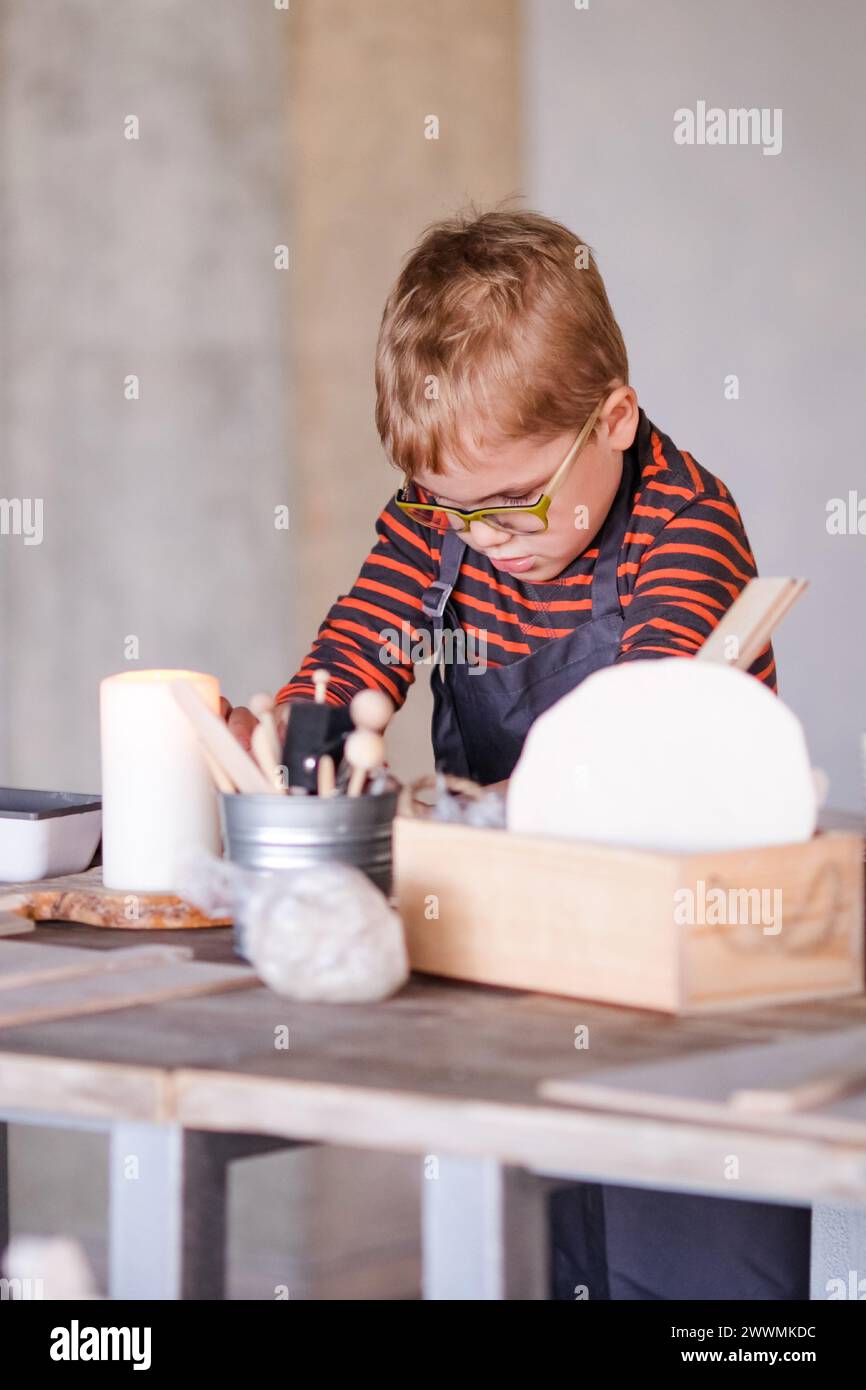 5-Year-Old Boy with Glasses Exploring Handmade Ceramics Stock Photo - Alamy