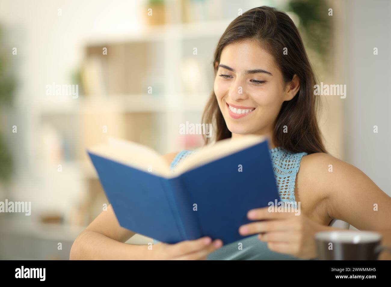 Teen girl reading book chair hi-res stock photography and images - Alamy