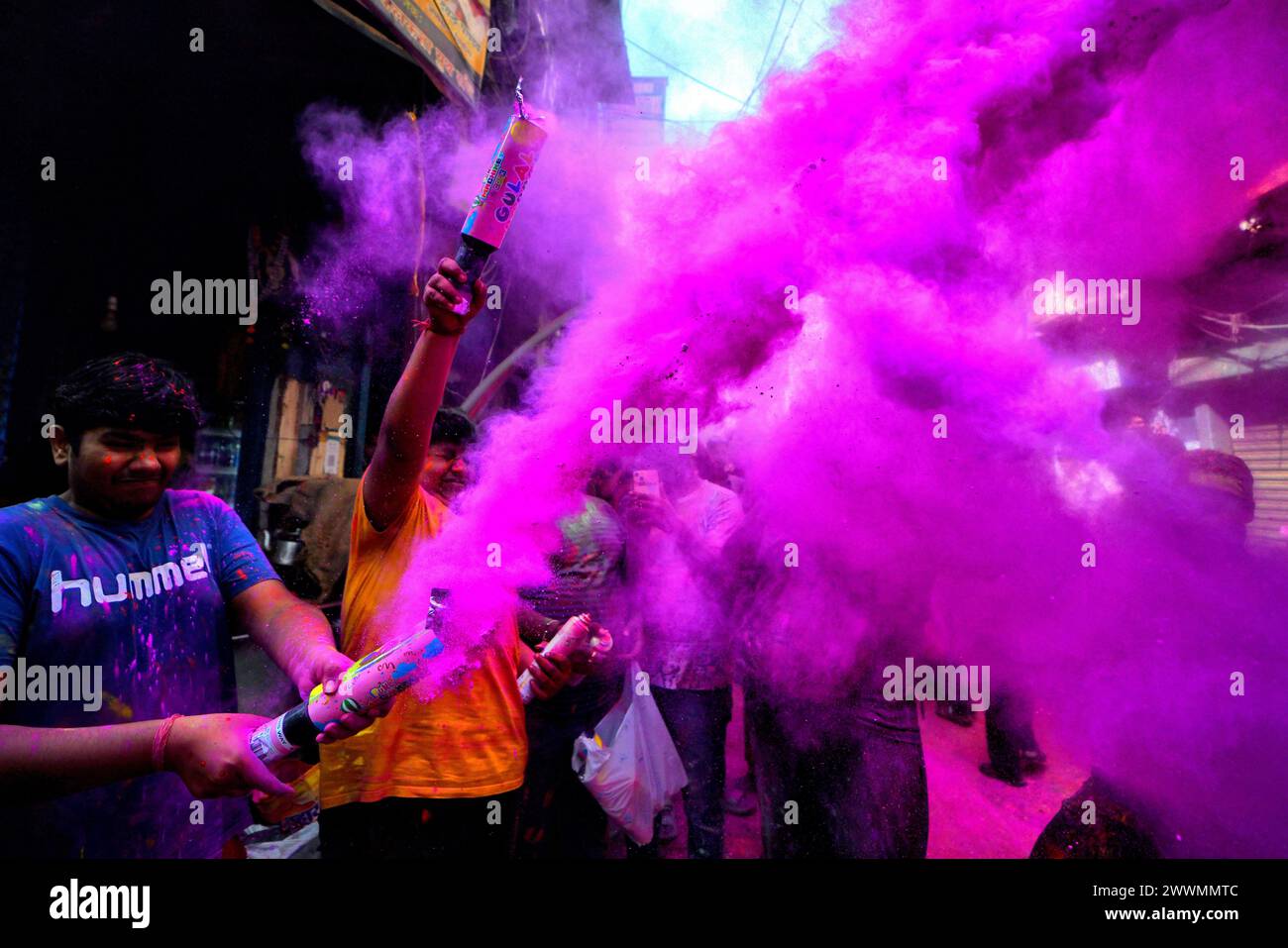 Kolkata, India. 23rd Mar, 2024. People are using colorful smoke stick ...