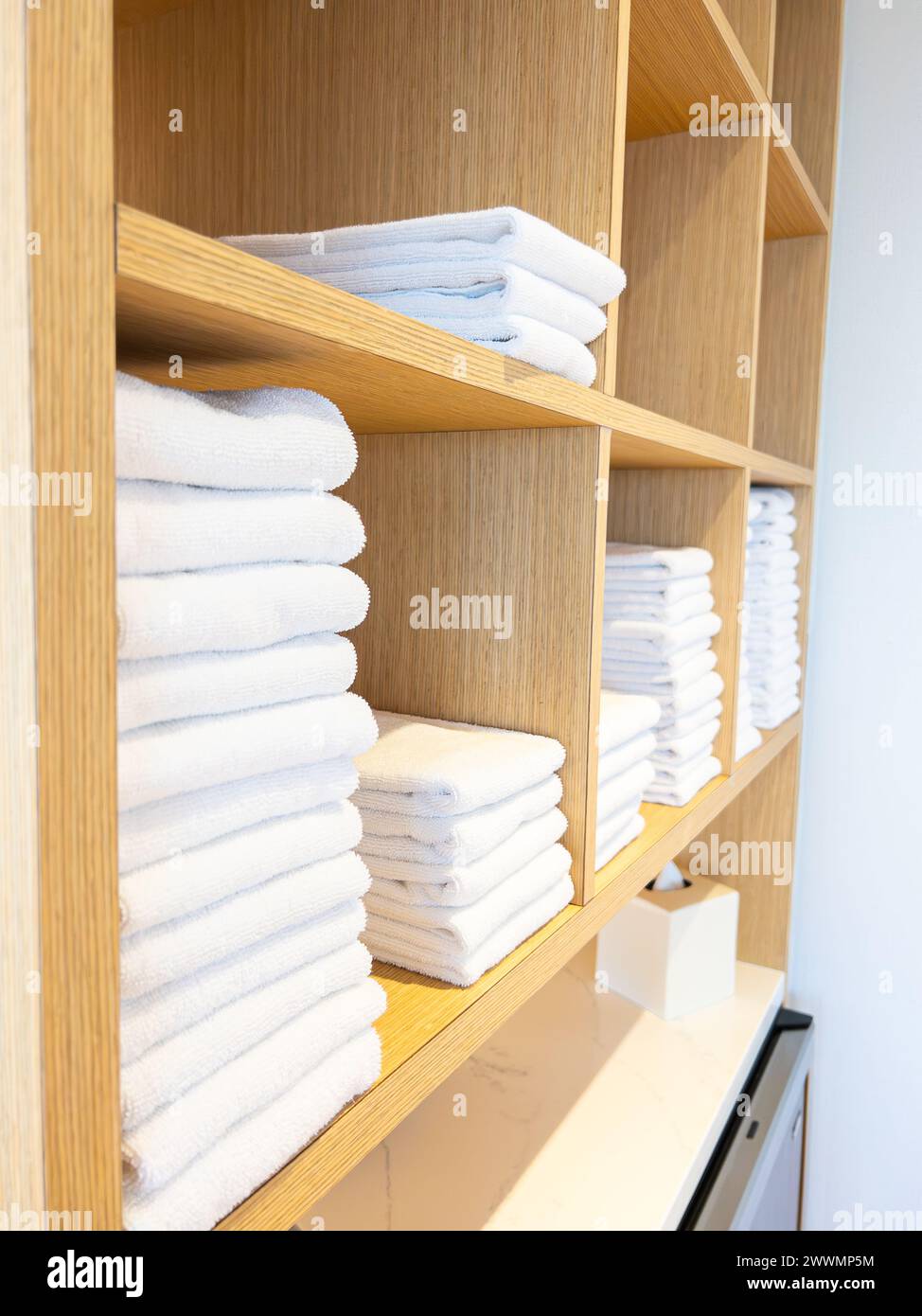 Neatly Stacked Towels on Wooden Shelves Display Stock Photo - Alamy