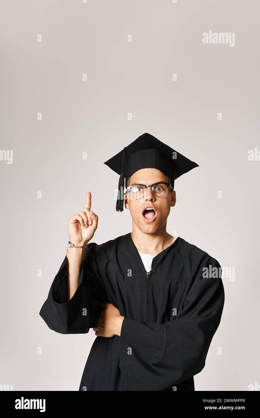 attractive young student in graduate outfit and vision glasses come up ...
