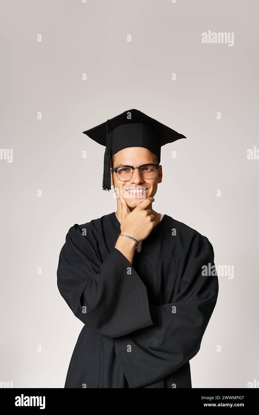 smiling student in graduate outfit and vision glasses touching hand to ...