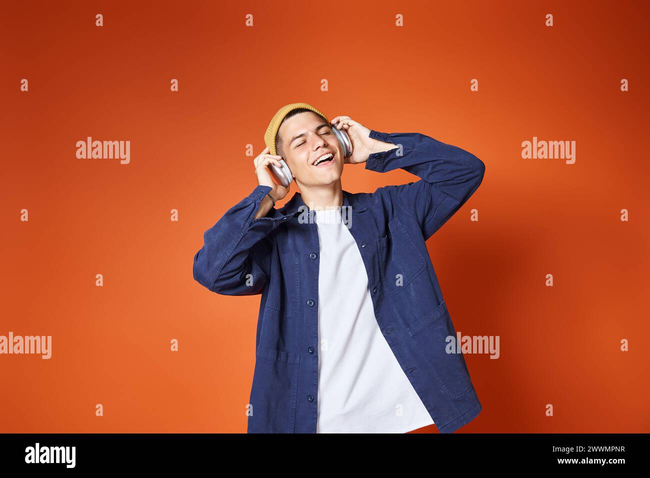 attractive young guy pleasure listening to music with headphones on ...