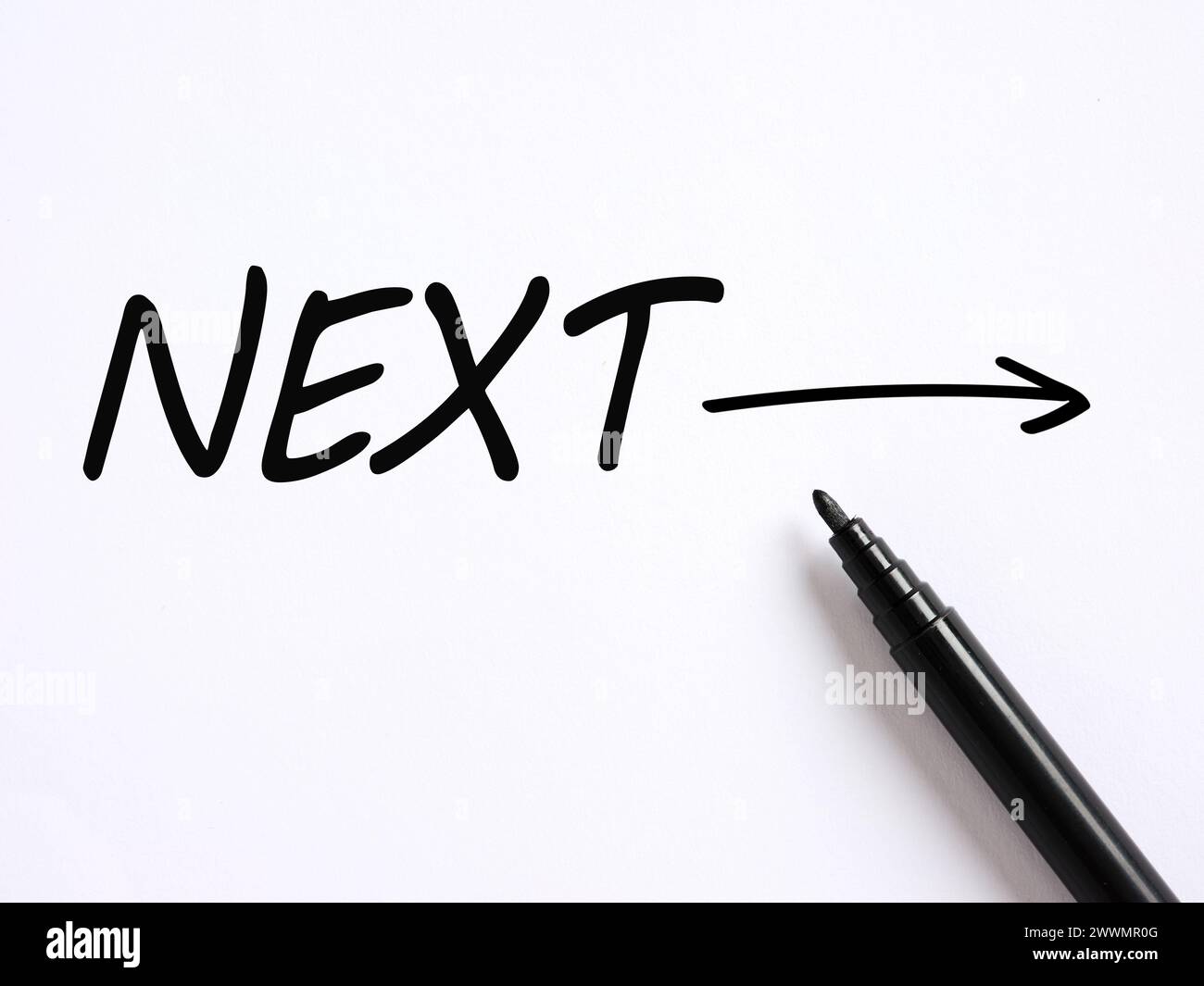 The word NEXT handwritten on white background. Next level or step in business or education ...