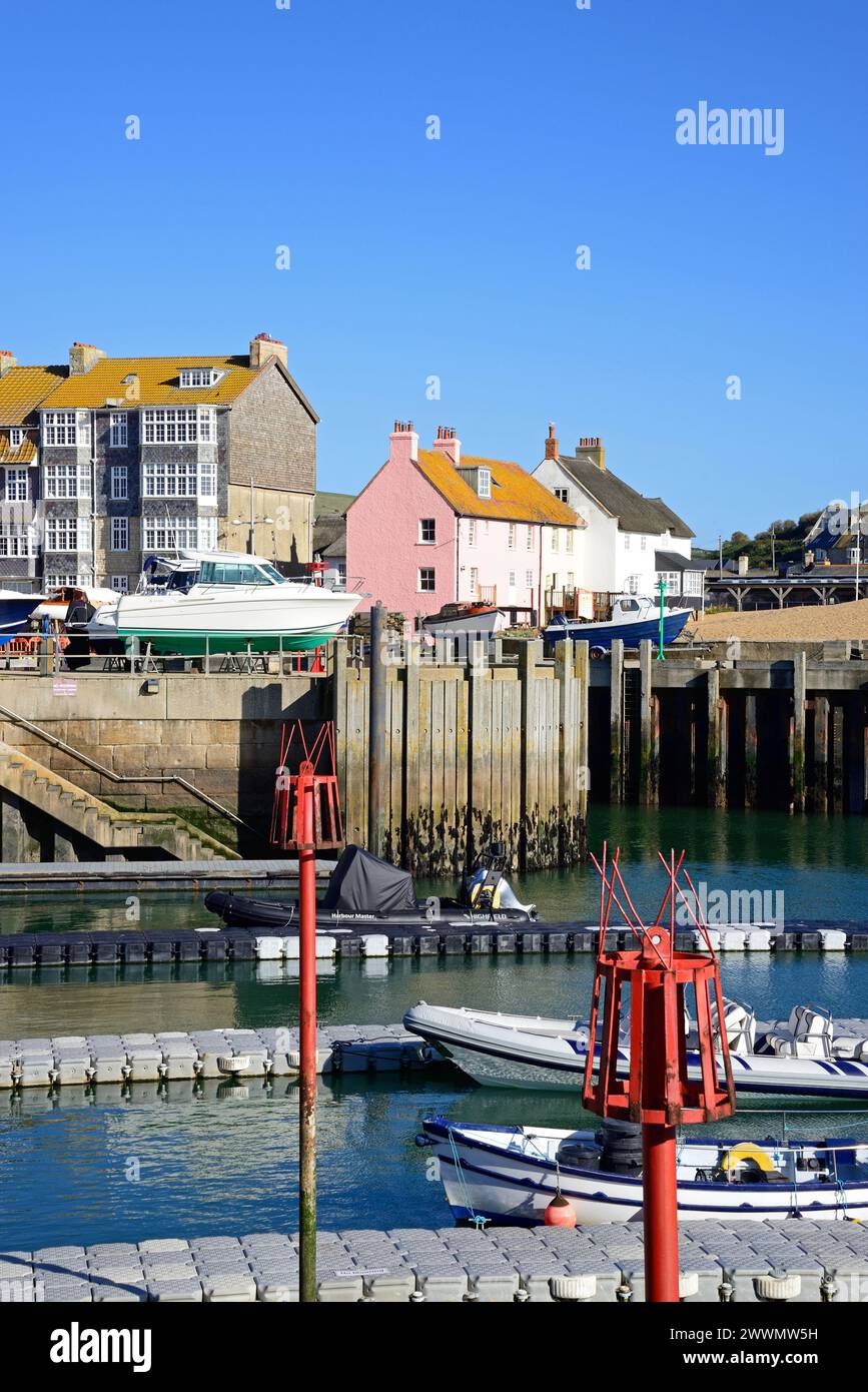 Navigation lights at the harbour entrance with boats in dry dock to the ...