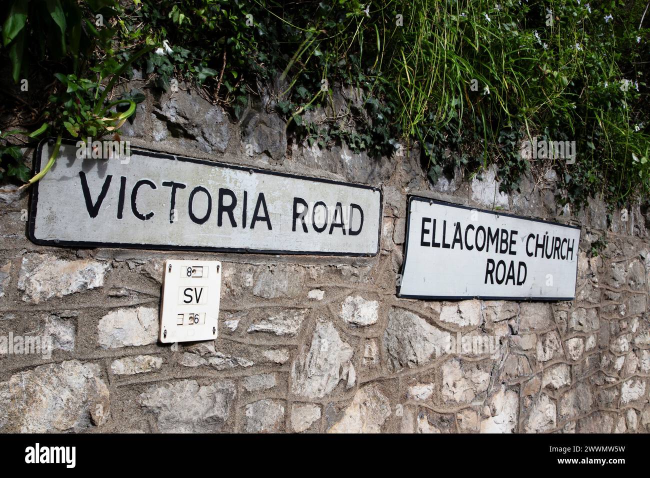 Victoria Road and Ellacombe Church Road sign against stone wall Stock ...