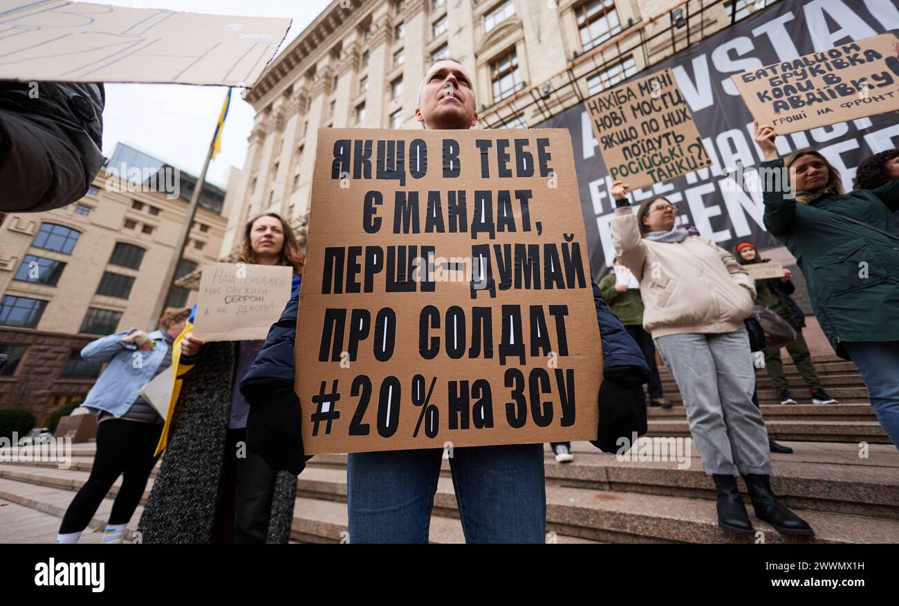 Ukrainian activist holds a banner "Deputies, Think Of The Soldiers ...