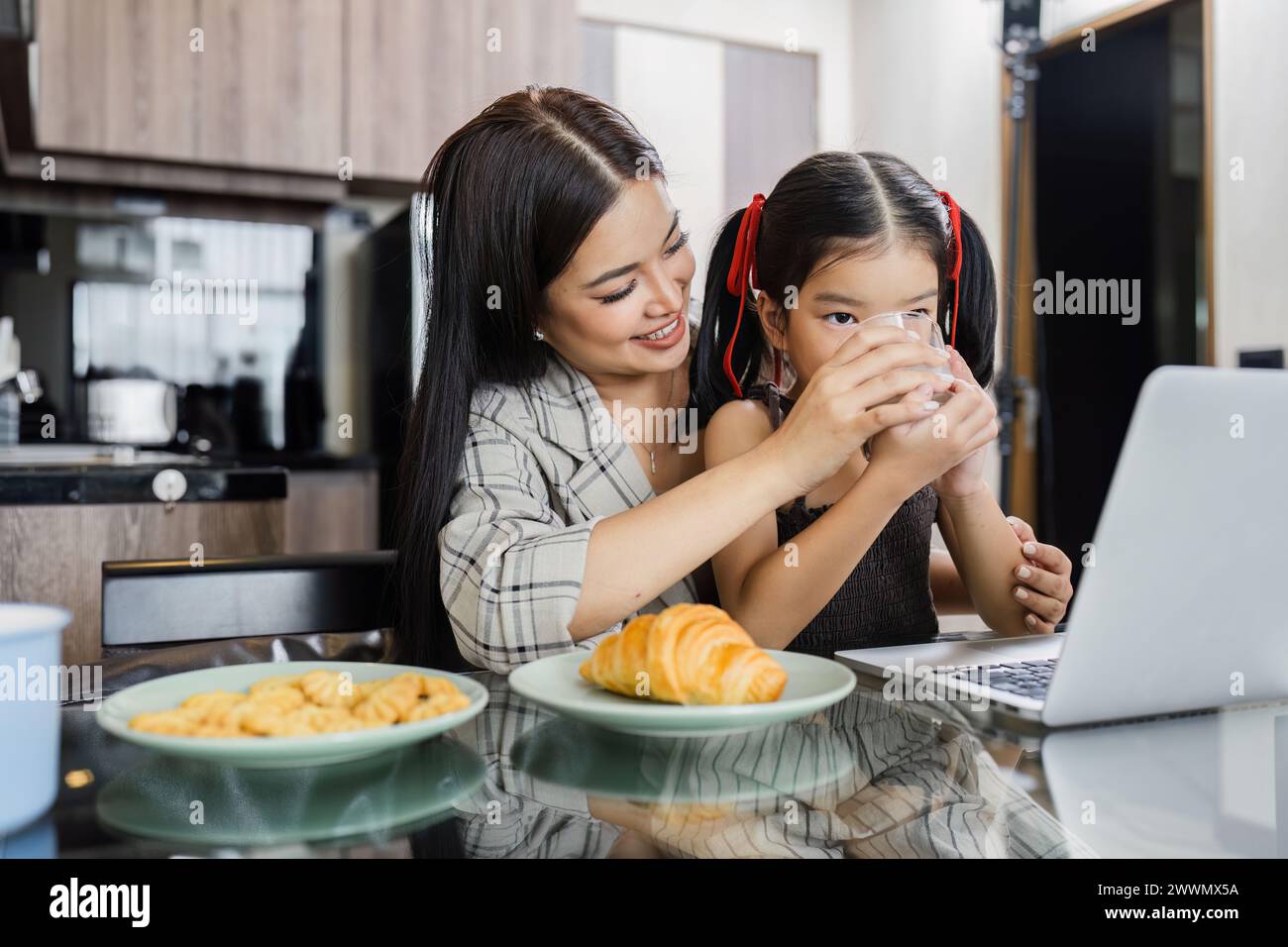business woman work from home and take care of her child while working ...