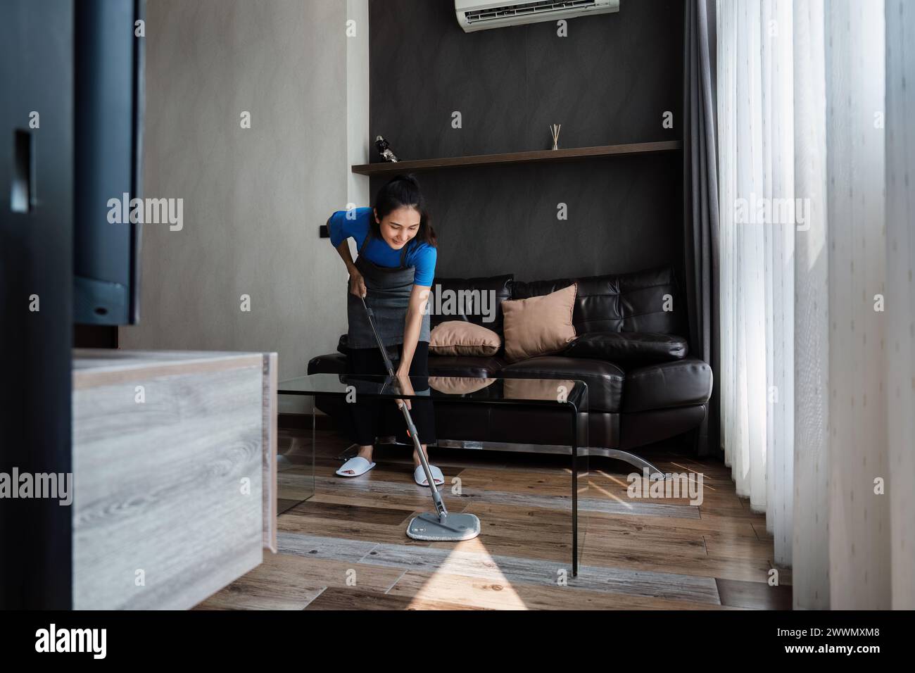 cleaning service housekeeper women swipe floor in living room. House ...