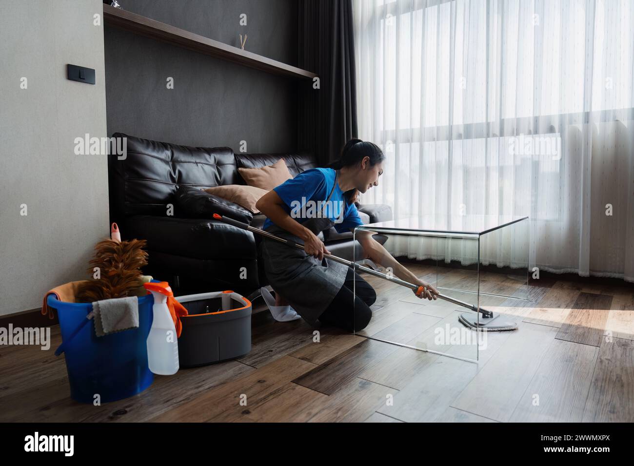 Housekeeping woman wiping the table in the living room House cleaning ...