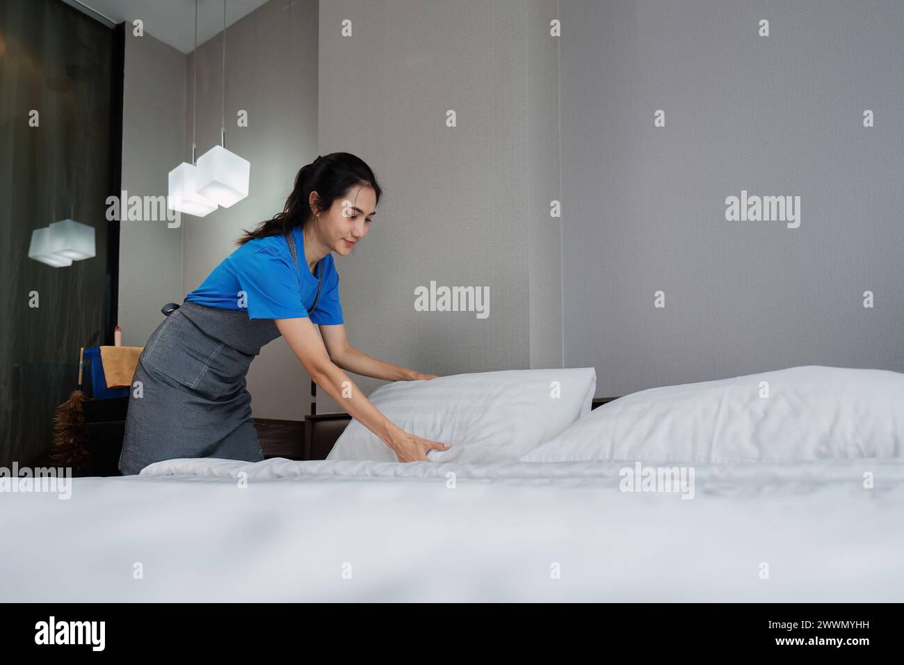 cleaning service woman worker clean bedroom at hotel. housekeeper ...