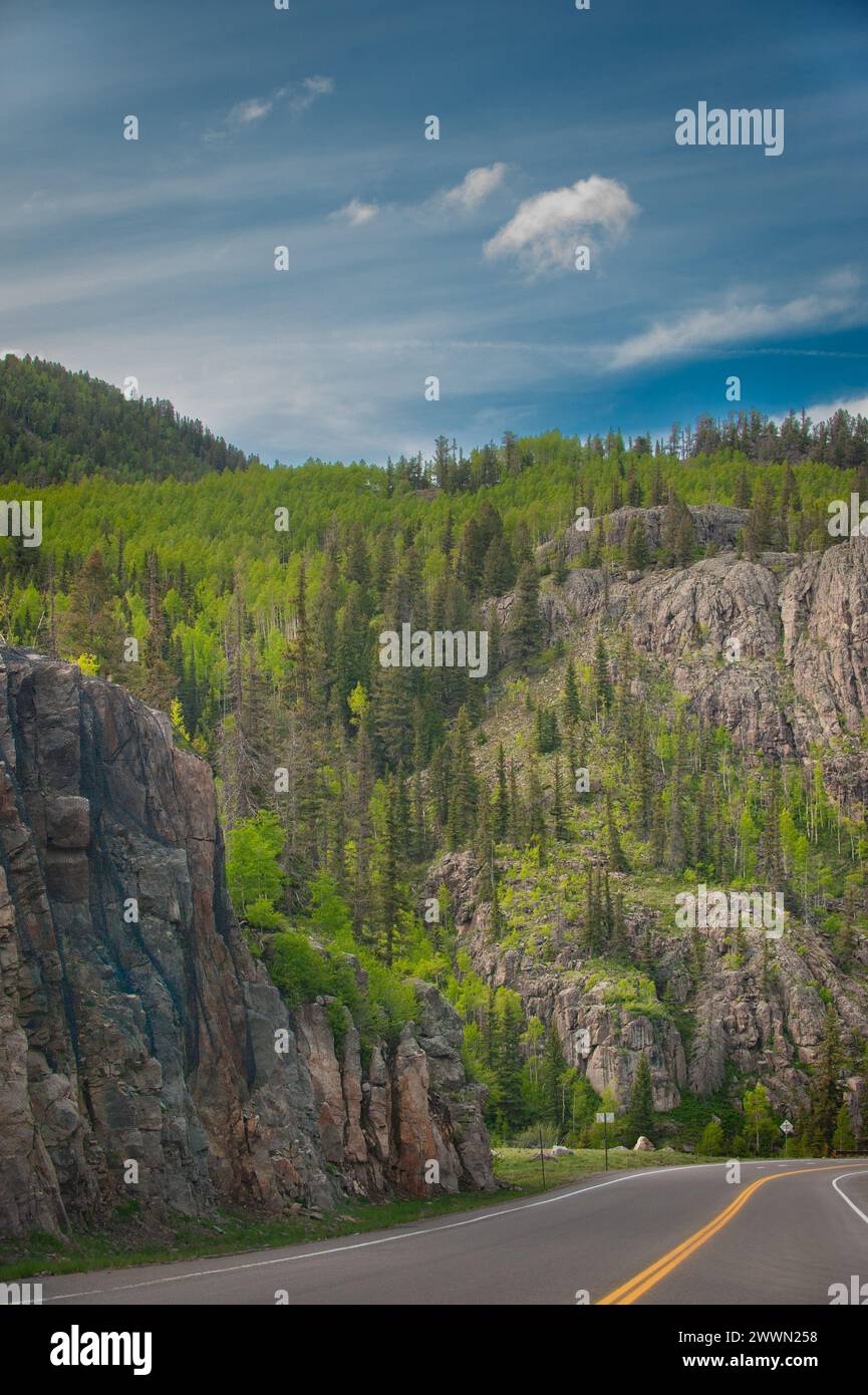 A scenic portrayal of a rough, rocky terrain covered with trees against ...
