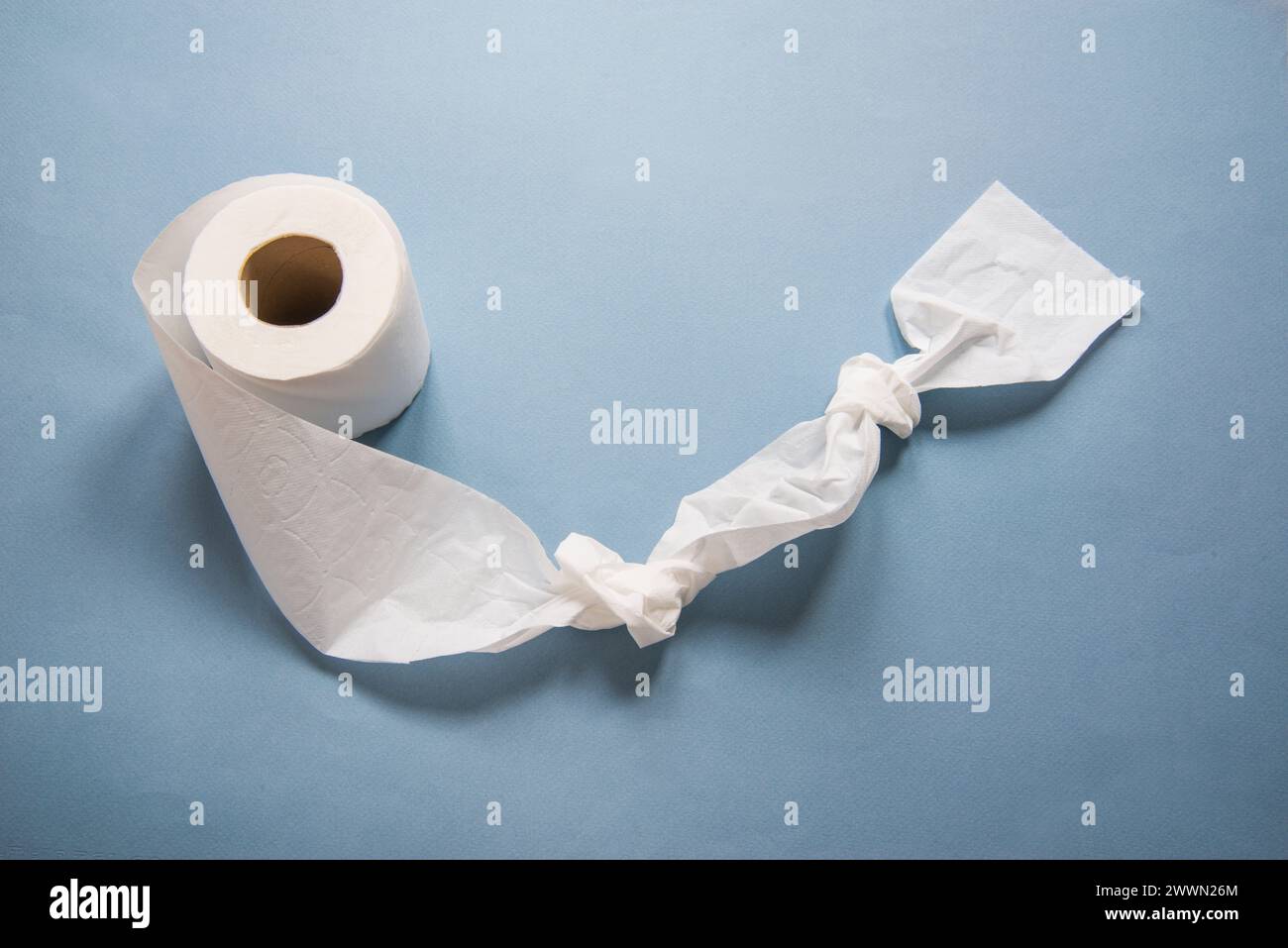 Roll of toilet paper with two knots Stock Photo - Alamy