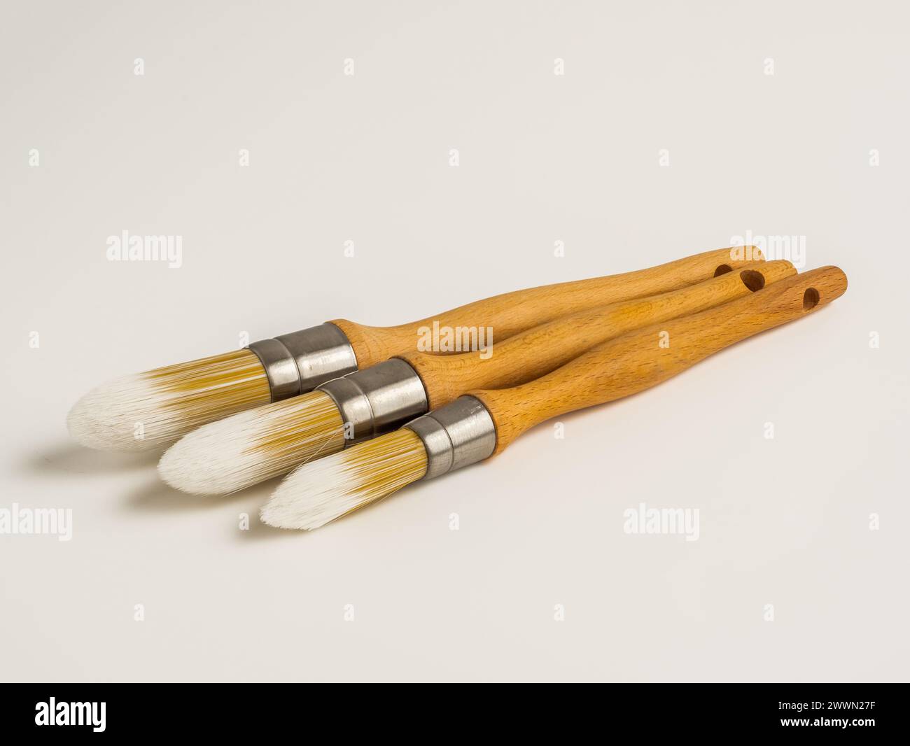 traditional set of wooden sash brushes isolated on a white background ...