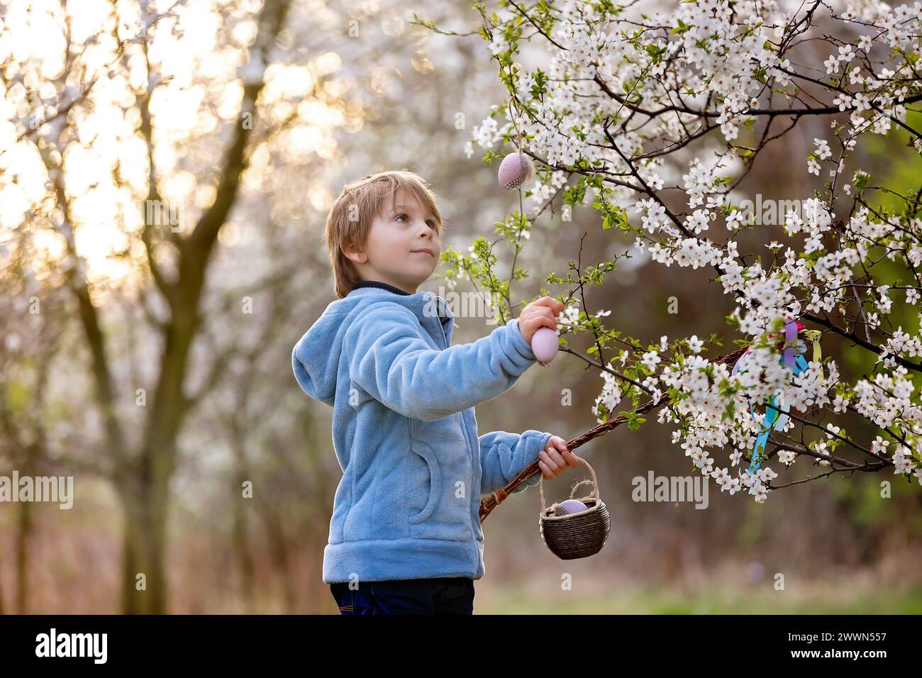 Beautiful blond child, boy, holding twig, braided whip made from pussy ...