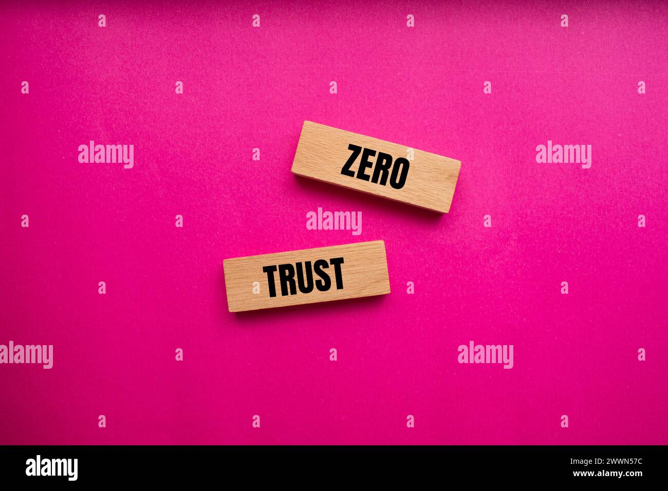 Zero trust words written on wooden blocks with pink background ...