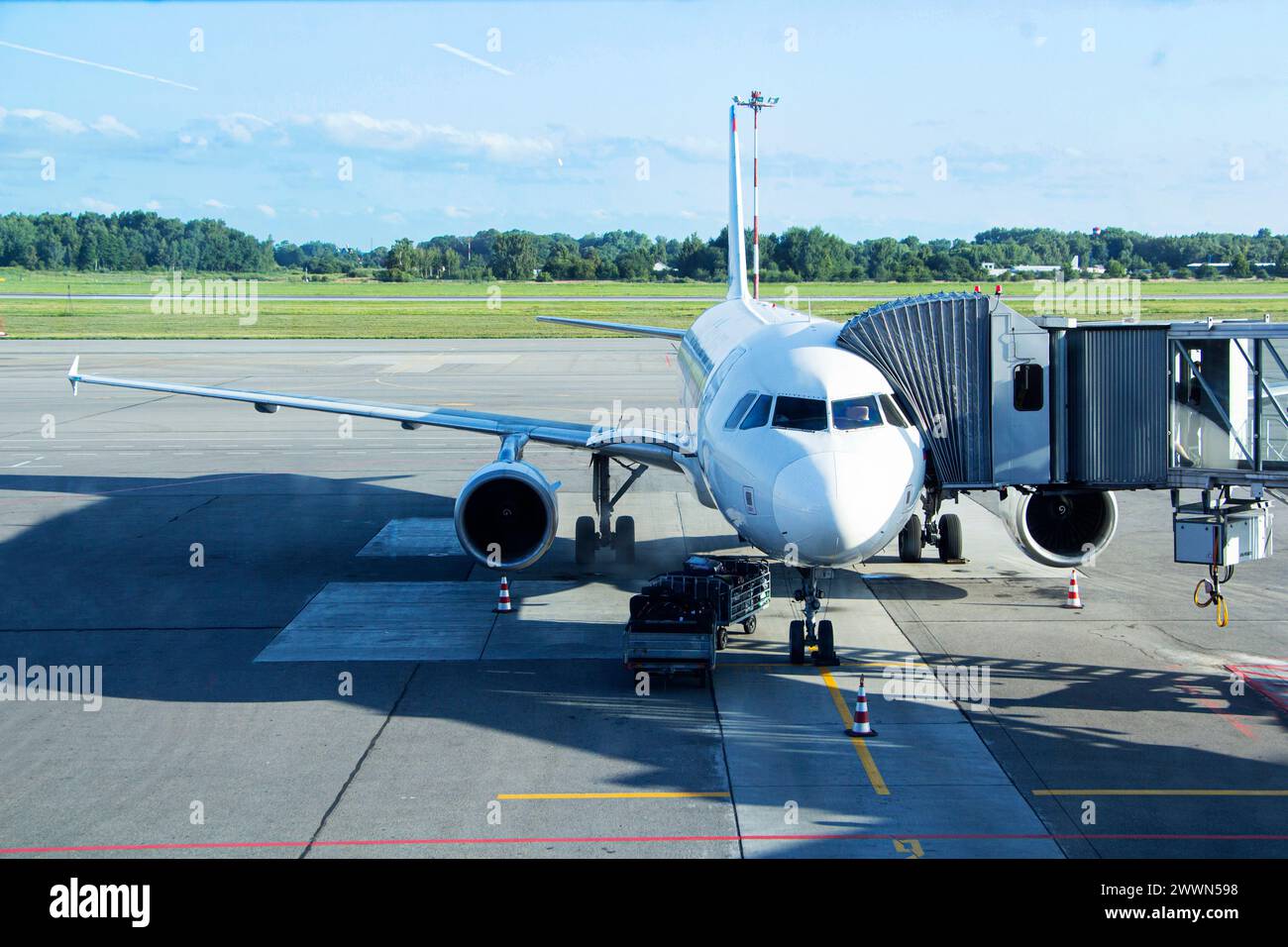Airplane getting ready to accept passengers with ground crew working ...