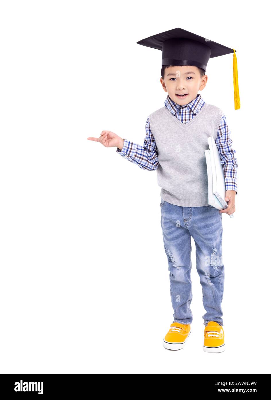 Happy Asian school kid graduate in graduation cap and hand pointing to ...