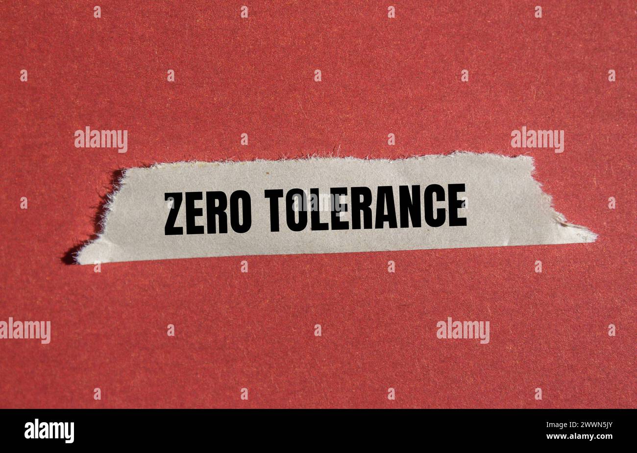 Zero tolerance words written on torn paper piece with red background. Conceptual photo. Copy ...